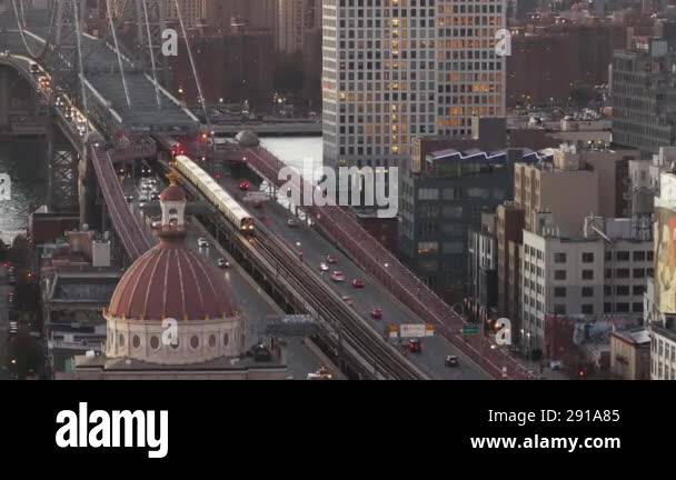 Aerial view of the subway crossing the Williamsburg Bridge. Shot at dusk on an autumn day in ...