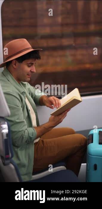 vertical relaxed traveler reads a travel guide to plan their route ...