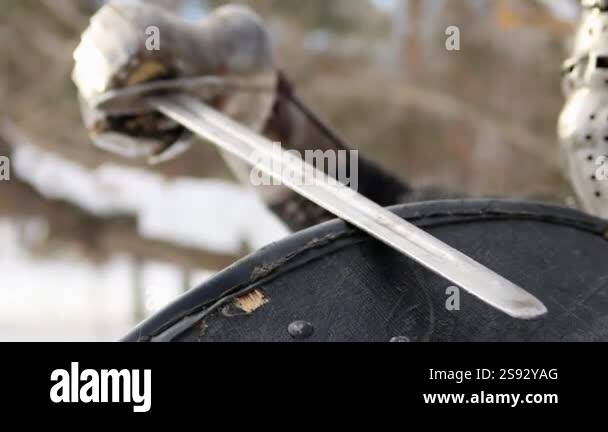Close-up of sword in knight's hands, smooth camera movement, selective ...