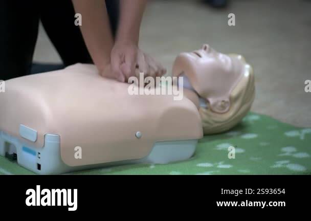Video demonstrates CPR on a dummy, showing proper chest compressions ...