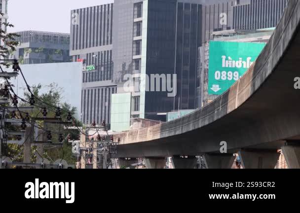 Sky train traveling along elevated tracks in city Stock Video Footage ...