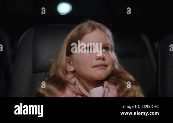 The young girl, feeling scared, covers her face with her hands during a ...