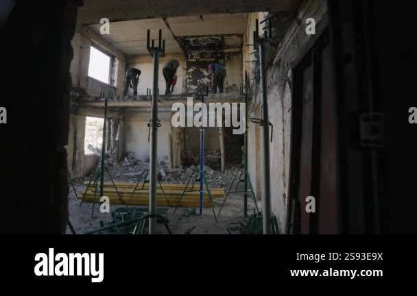 Using jackhammers, men demolish, clear debris for reconstruction ...