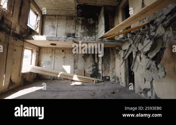 Damaged walls, collapsed ceilings in residential building. Burnt ...