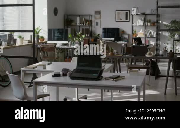 Interior of spacious modern office with work desks and computers with ...