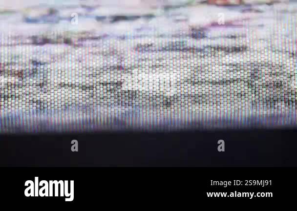 A close-up of a retro CRT television screen displaying flickering ...