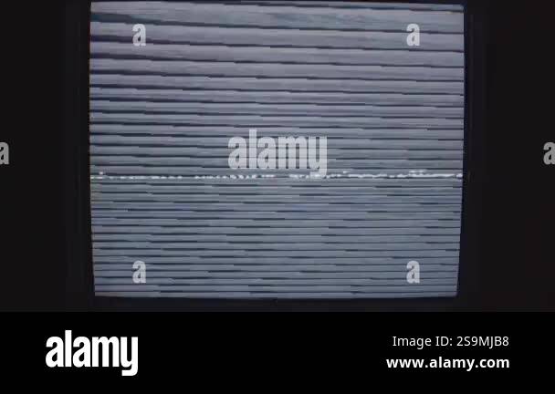 A vintage CRT TV screen displaying flickering static noise intertwined ...