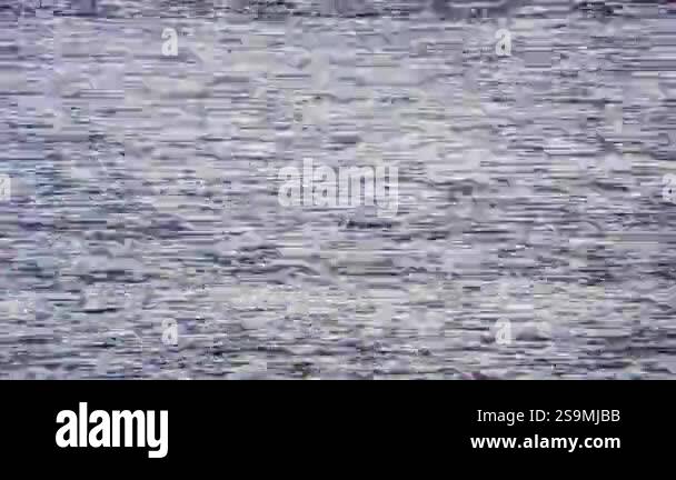 A vintage television screen displays flickering static snow, capturing ...