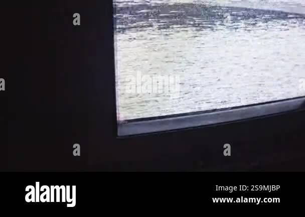 A vintage CRT television screen displaying dynamic static glitches ...