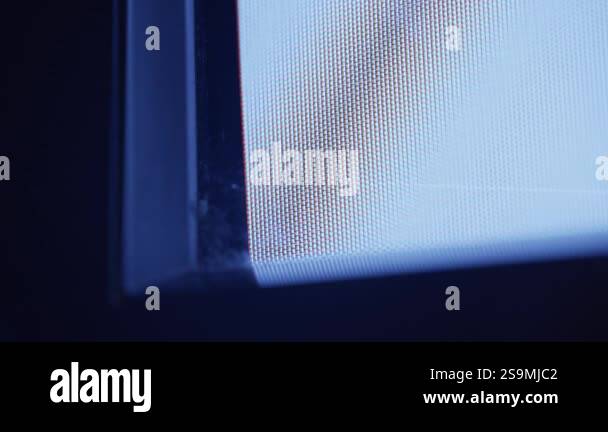 Close-up of a vintage CRT television screen displaying a classic blue ...