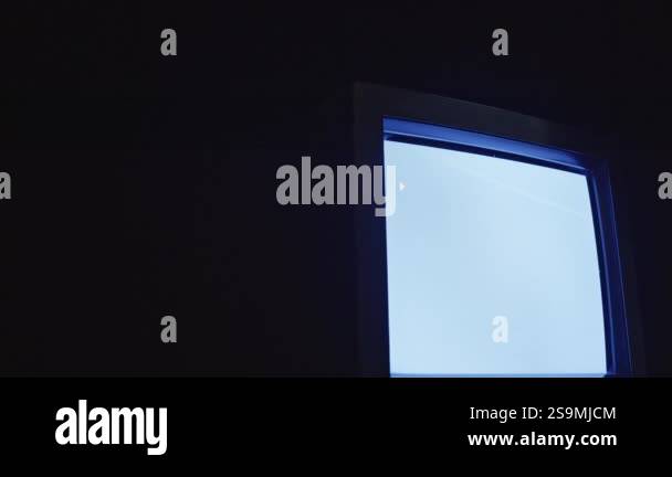 A vintage CRT TV screen displaying a noisy static effect with ...