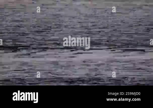 A vintage VHS tape shows static interference that gradually transitions ...