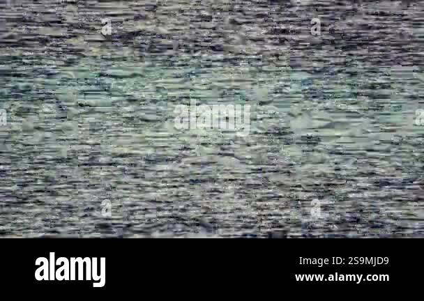 A vintage VHS tape playback showing static noise, screen distortion ...