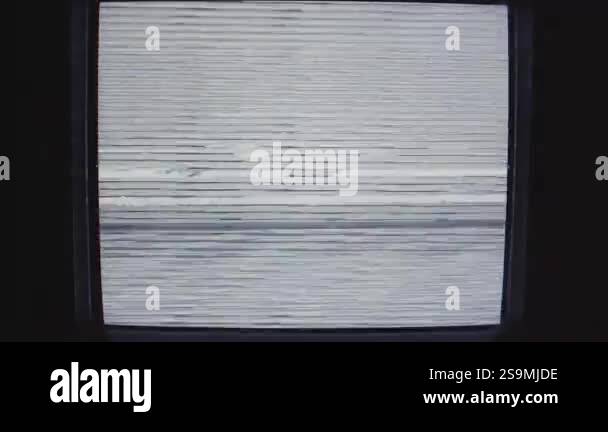 A CRT TV screen displaying static noise with visible horizontal scan ...