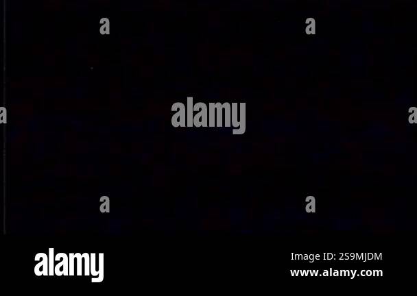 A VHS tape glitches, displaying distorted fuzzy static noise with ...