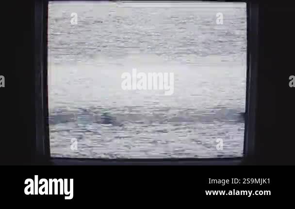 A retro CRT TV screen displaying glitchy static noise, with visual ...