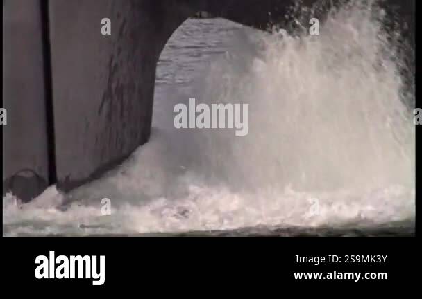 A close-up shot captures the underside of a ship's hull as it moves ...