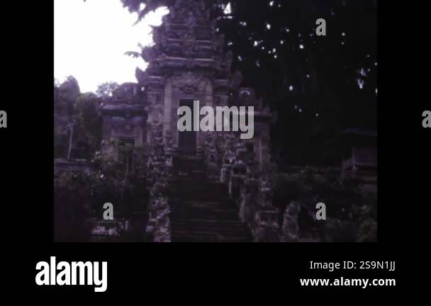 Denpasar, bali june 1985: stone steps ascend to a weathered temple ...