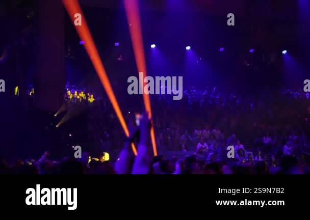 Hands hold camera with digital display among people at party, view from ...