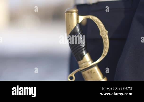 Sabre from sheath. Soldier dressed in a blue dress uniform and white ...
