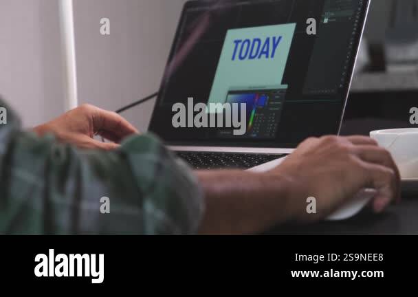 A laptop with the word today written on it. A person is writing on a ...