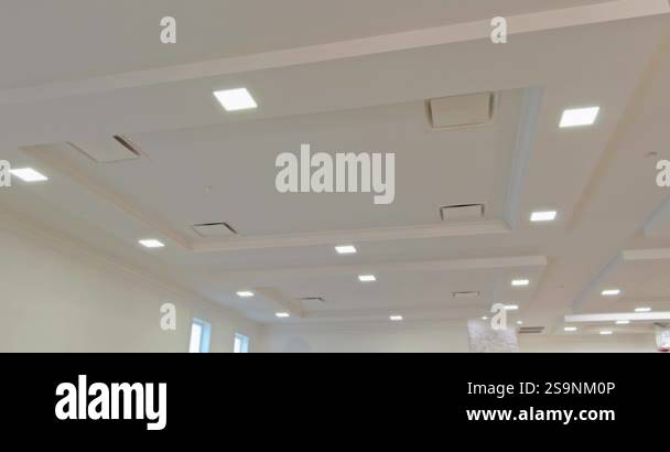 Bright indoor area featuring a contemporary ceiling layout with ...