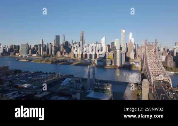 Golden sunlight illuminating Manhattan skyline, Queensboro Bridge ...