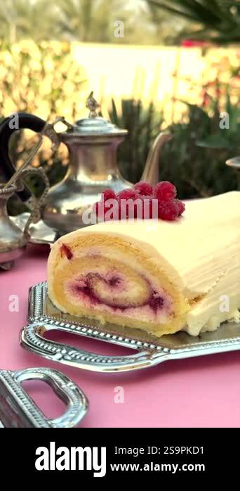 Cake dessert roll decorated with berries, creamy layers creating smooth ...