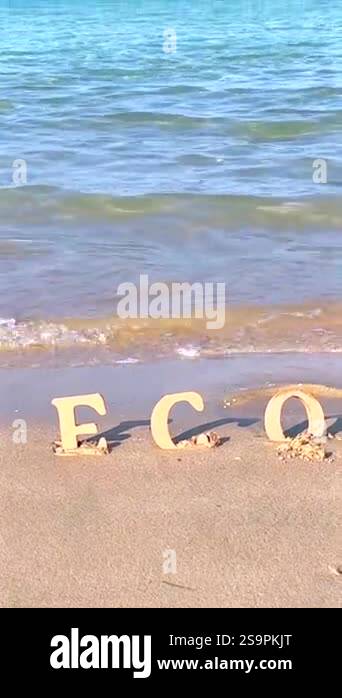 Eco letters on sandy coastline highlight environmental balance, eco ...