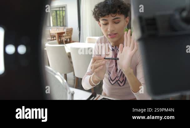 Applying makeup, non binary person using brush while recording video at home. Beauty, vlogger ...