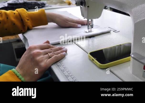 sewing. close-up. seamstress sews fabric on sewing machine. Sewing ...