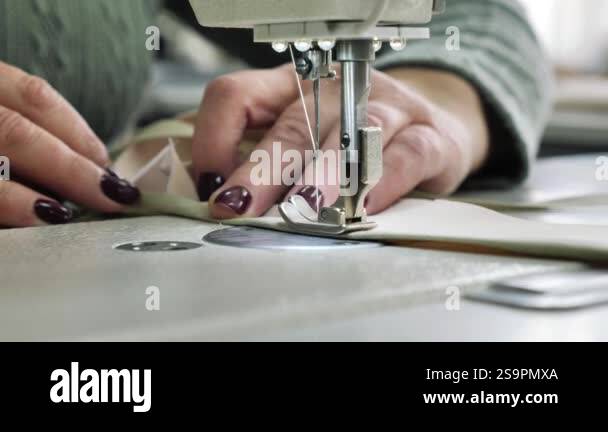 sewing. close-up. seamstress sews fabric on sewing machine. Sewing ...