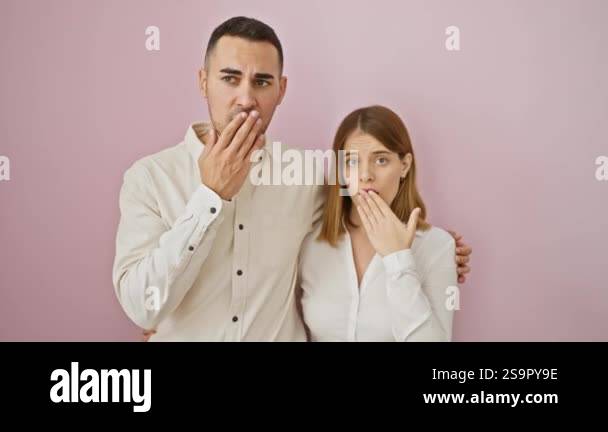 Beautiful couple together, silent shock over mistake. mouth covered by ...