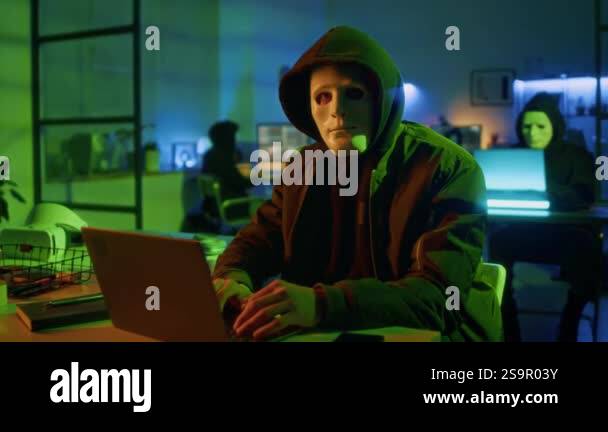 Portrait of male computer criminal wearing hacker mask posing for ...