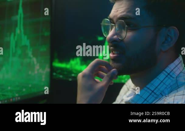 Displeased Indian Arabian man broker guy programming code cryptocurrency computer trading ...