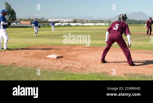 Helping teammate stand up, baseball player assisting another on field ...