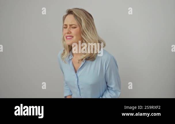 Painfully sick young blonde woman suffering stomachache, hand on aching ...