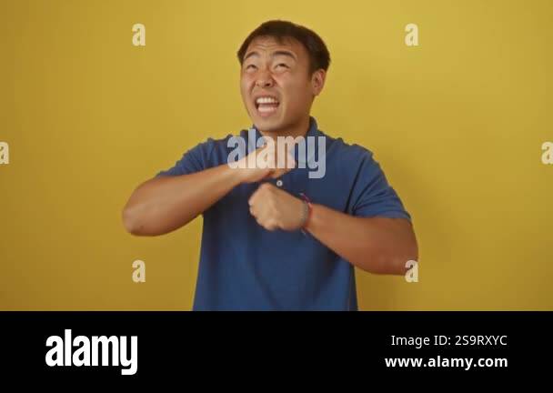 Angry young chinese man standing furious and mad, screaming and ...