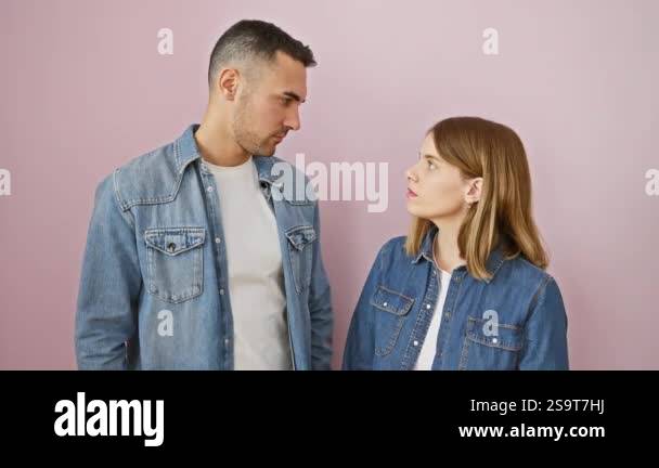 Confident yet simple couple in love, flaunting a serious look in denim ...