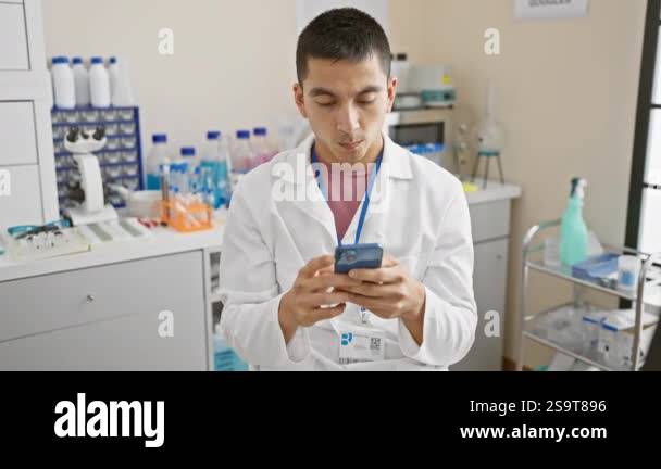 Cheerful young hispanic man, proud scientist in uniform, confidently ...