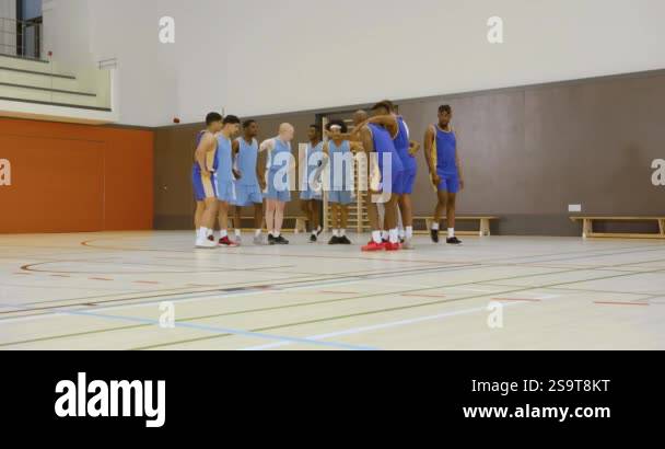 Basketball team celebrating victory on court, showing teamwork and ...
