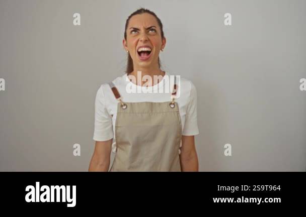 Woman showing frustration against a white wall with an isolated ...