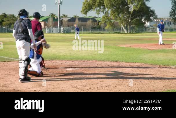 Playing baseball, batter ready to hit while catcher and umpire watch ...