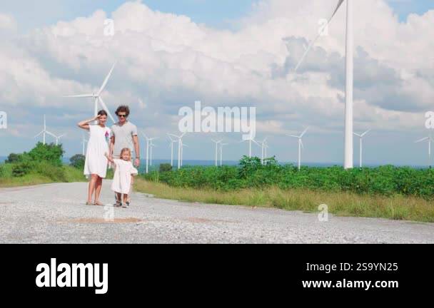 Happiness family walking wind turbine farm while father, daughter and ...