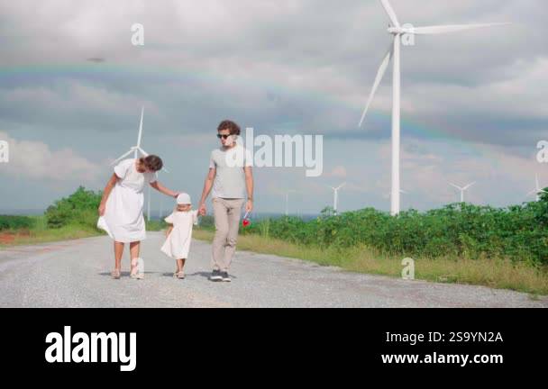 Happiness family walking wind turbine farm while father and daughter ...