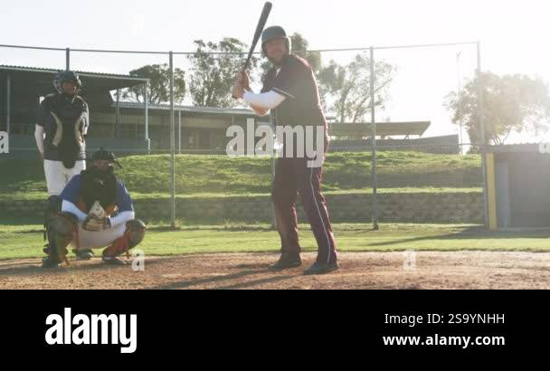 Playing baseball, batter holding bat while catcher and umpire ready on ...