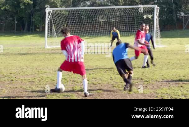 Playing soccer, team reacting to missed goal opportunity on field ...