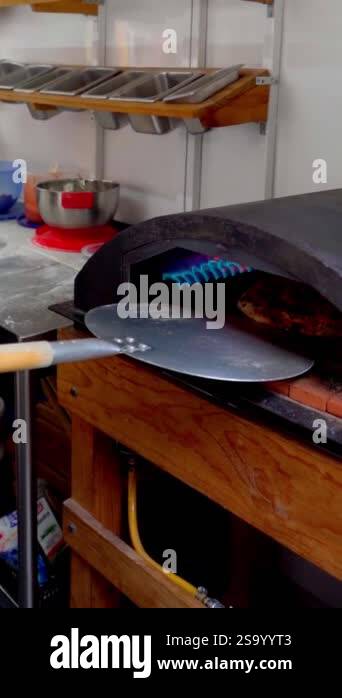 A freshly baked pizza, still steaming from the intense heat, shows off ...