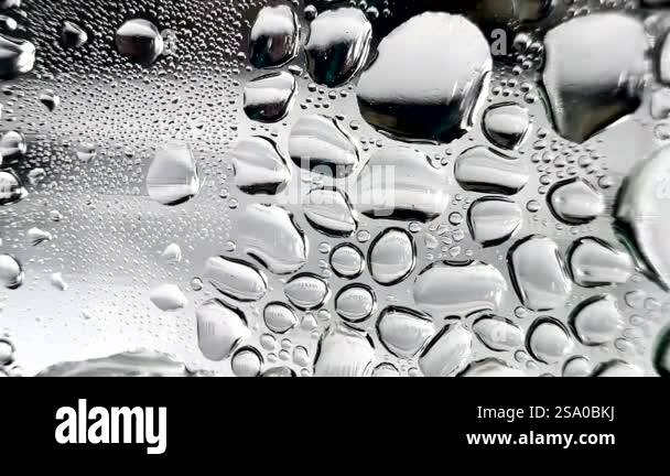 4k Close-up of water drops on metal surface in high resolution showing ...