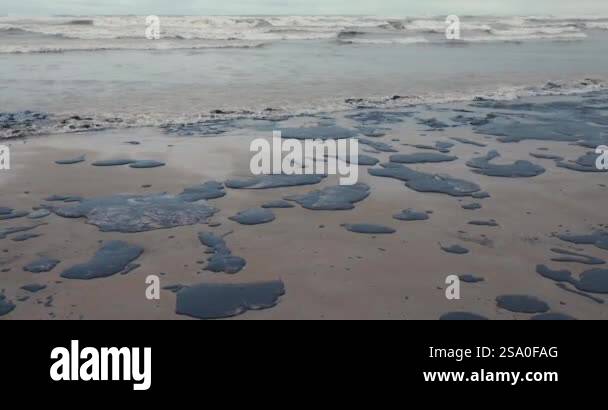 Oil in ocean coastline after a tanker wreck. Oil fuel polluted and ...